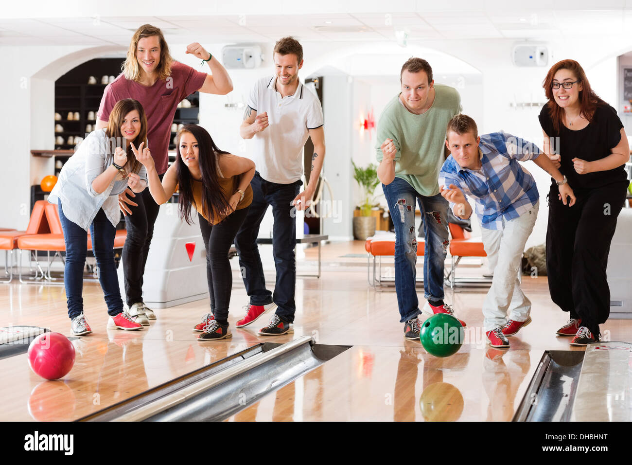 Young Friends Bowling While People Cheering Stock Photo - Alamy