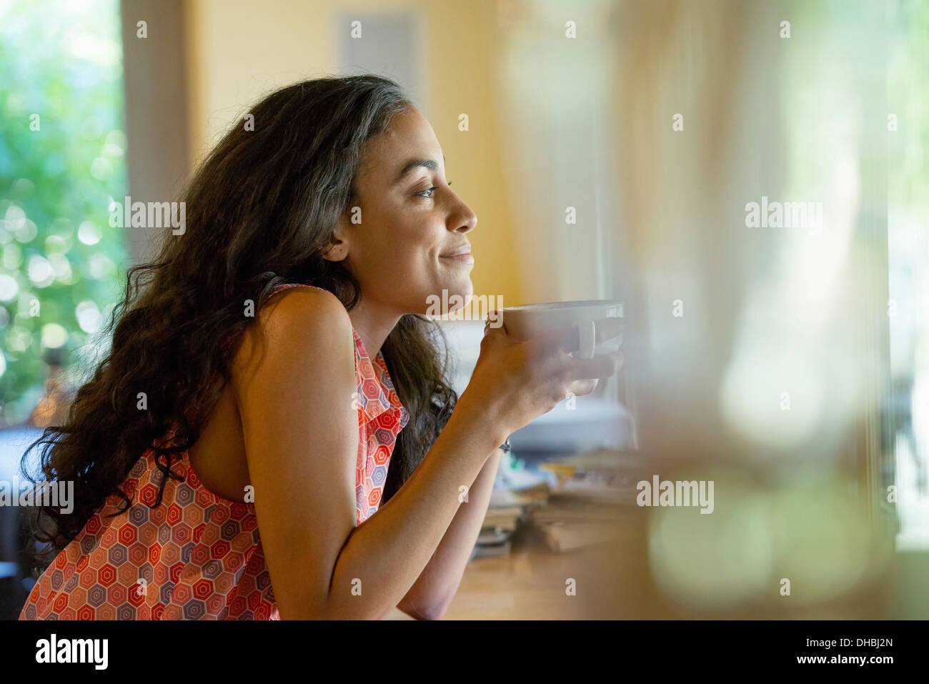 A woman sitting alone in a cafe, having coffee Stock Photo - Alamy