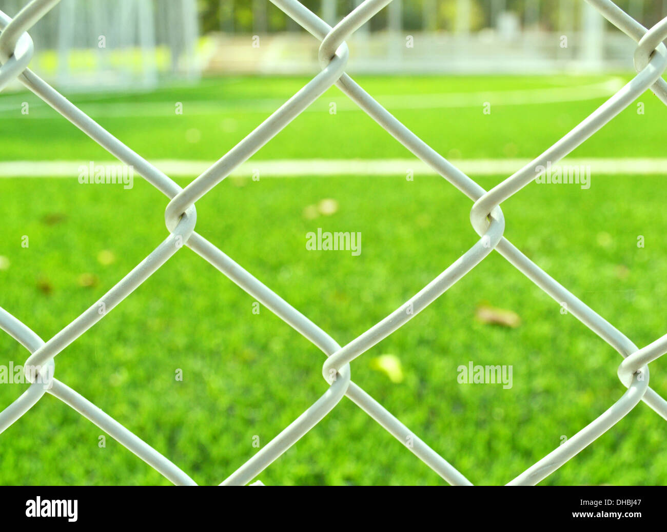 Metal net at soccer field with green grass Stock Photo - Alamy