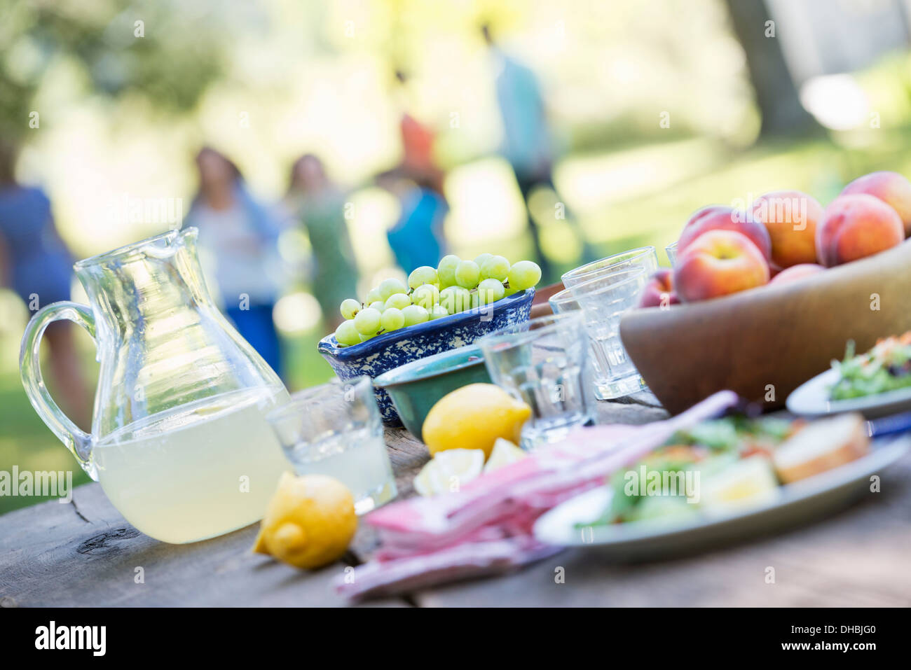 A summer buffet of fruits and vegetables, laid out on a table. People ...