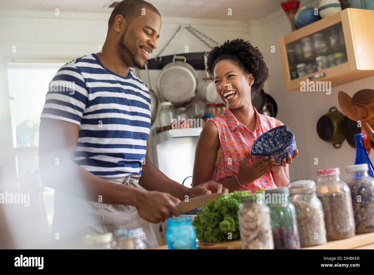 Lifestyle. Two people working in a farmhouse kitchen Stock Photo - Alamy