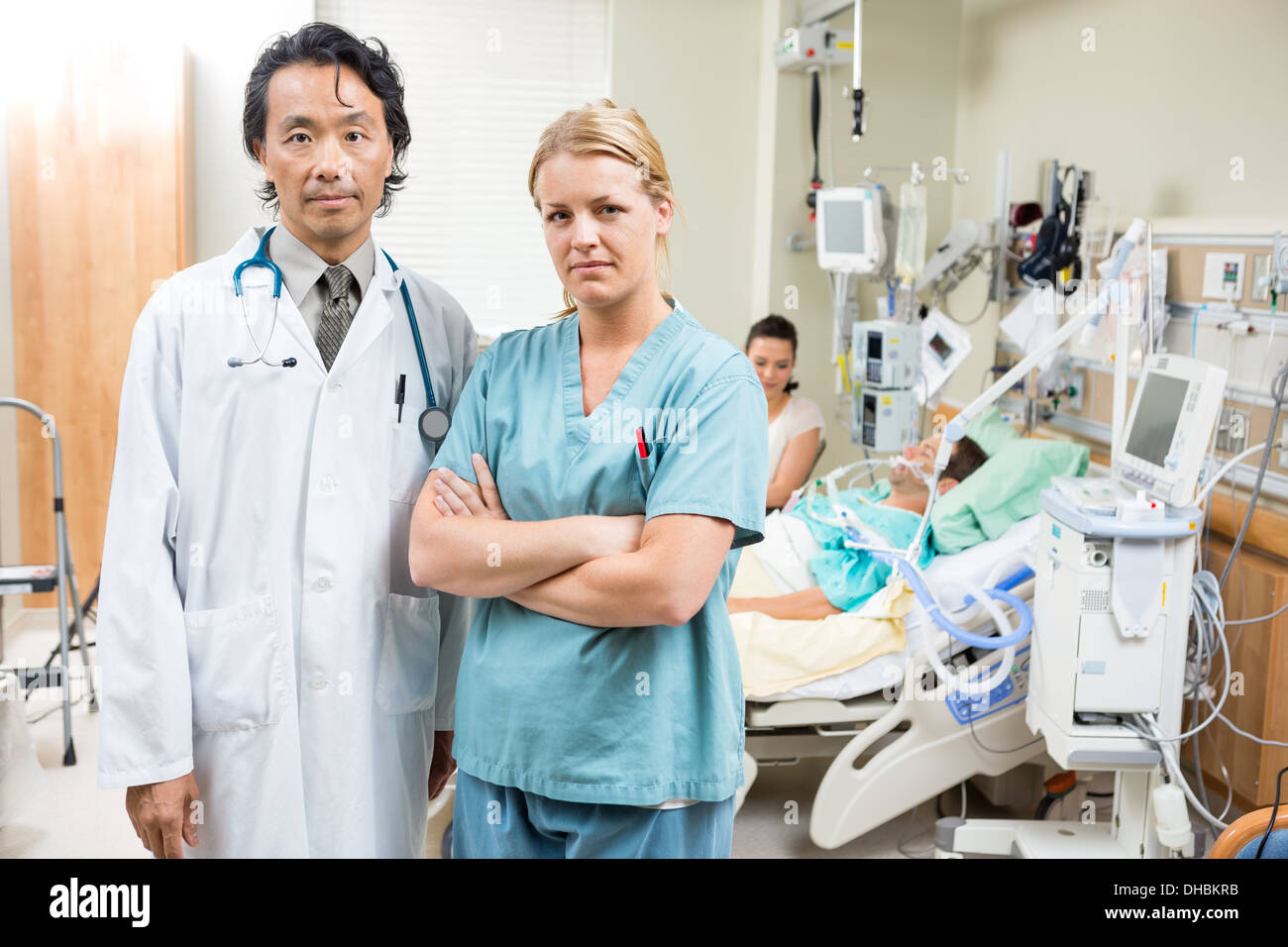 Confident Doctor And Nurse With Patient Resting In Hospital Stock Photo ...