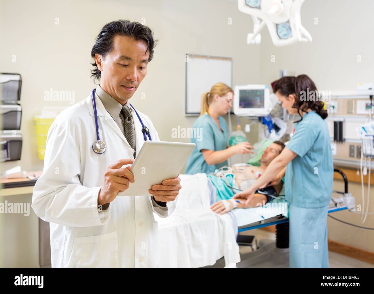 Medical Team Treating Patient In Hospital Stock Photo - Alamy