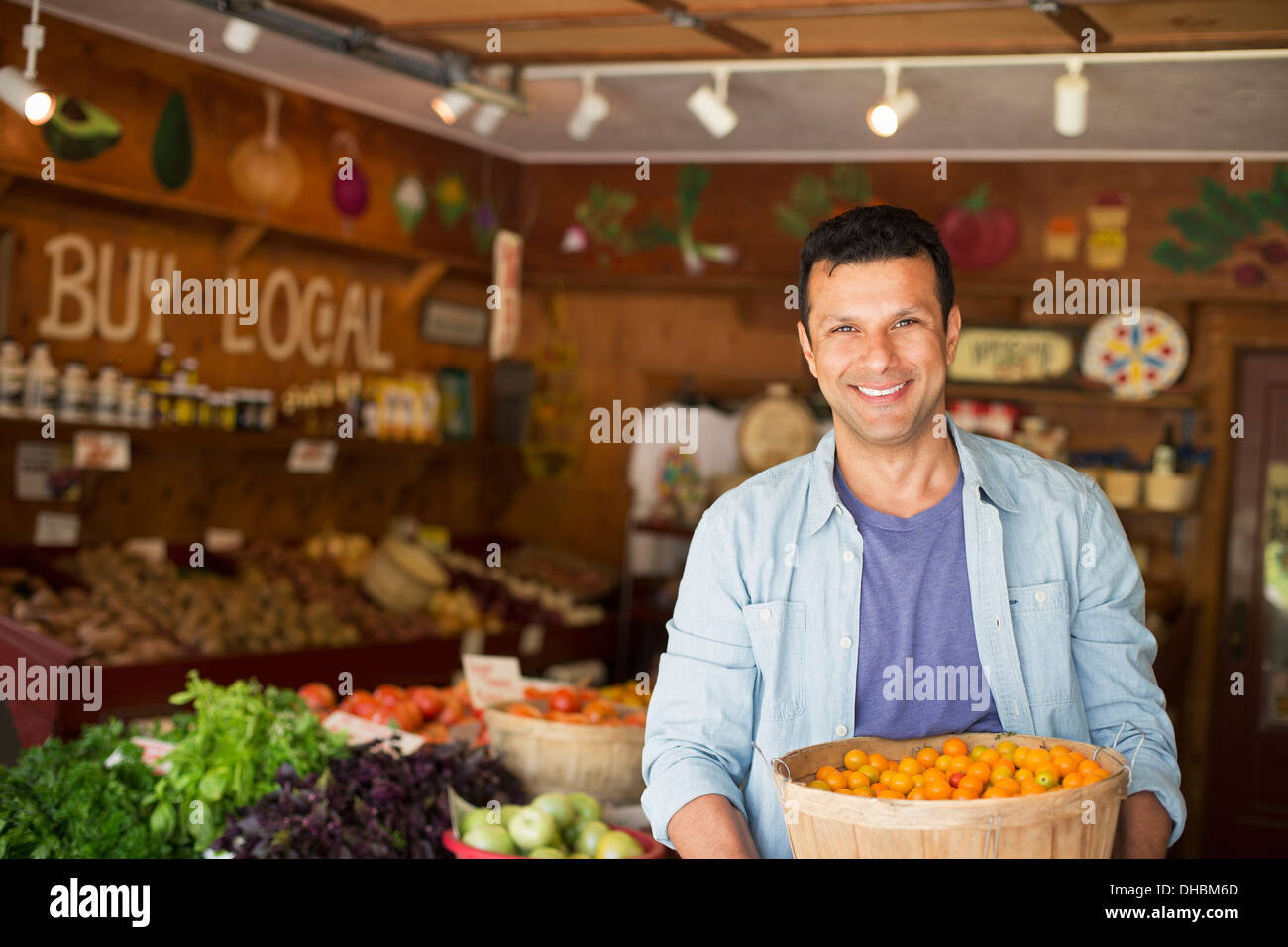 A farm growing and selling organic vegetables and fruit. A man holding ...