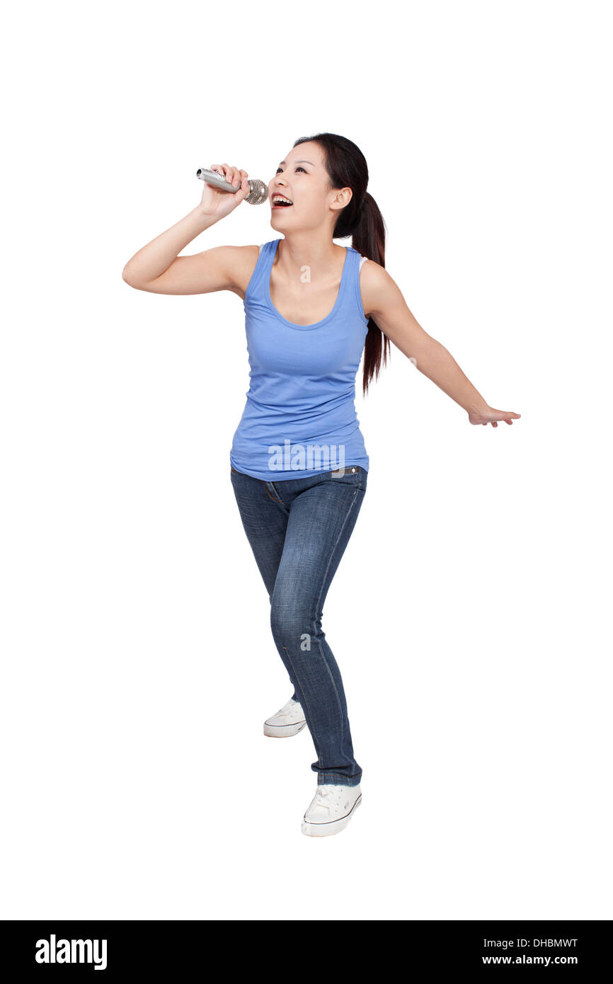 Studio portrait of young woman singing into microphone Stock Photo - Alamy