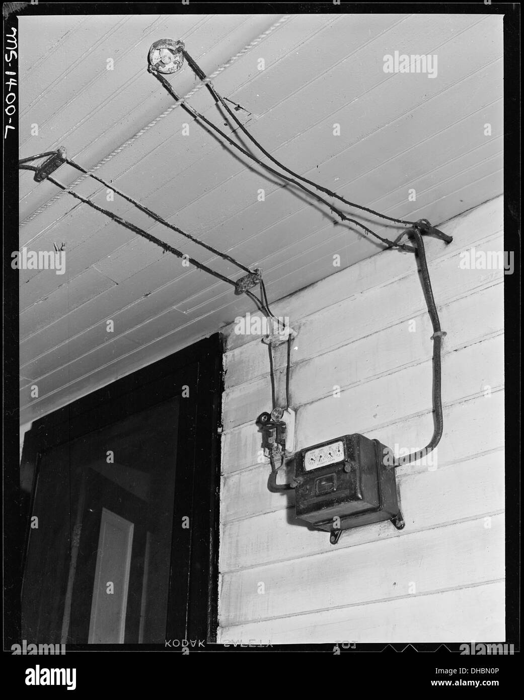 The electricity meter and wiring are shown on the porch of a house ...