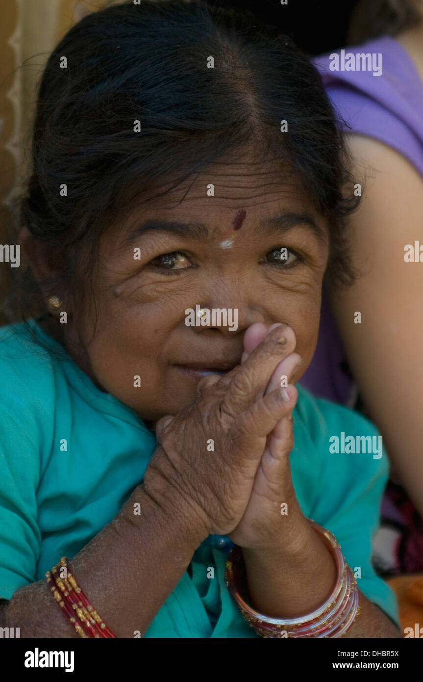 South Indian dwarf lady with folded prayerful hands in welcome sitting ...