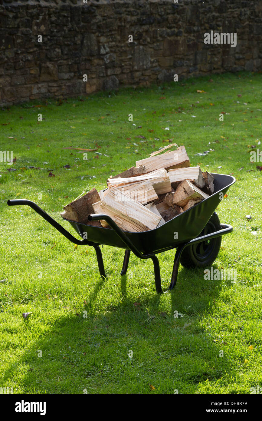 Wheelbarrow full of logs Stock Photo - Alamy