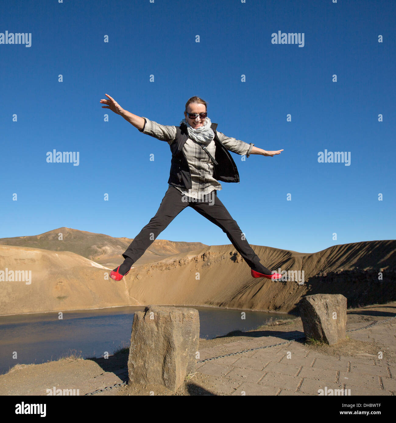 Jumping on a sunny day by Viti lake, an explosion crater near Krafla ...