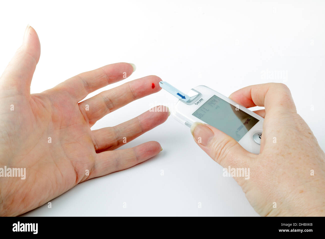 Diabetic blood glucose test - using a meter with blood on finger tip ...