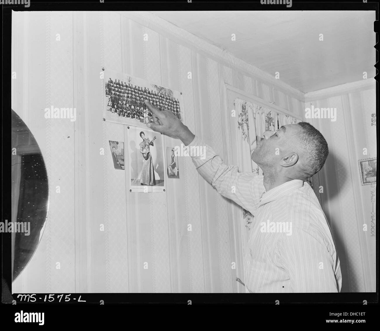 This photograph captures George Williams, a miner, proudly pointing out ...