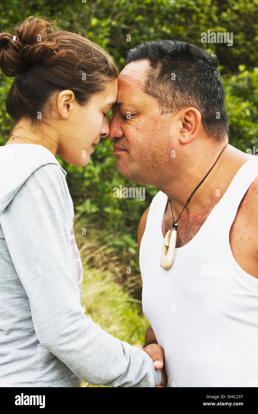 Tourists try traditional maori greeting hi-res stock photography and ...