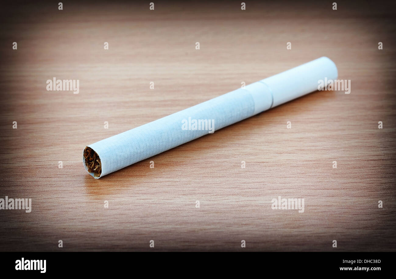 Cigarette on desk Stock Photo - Alamy