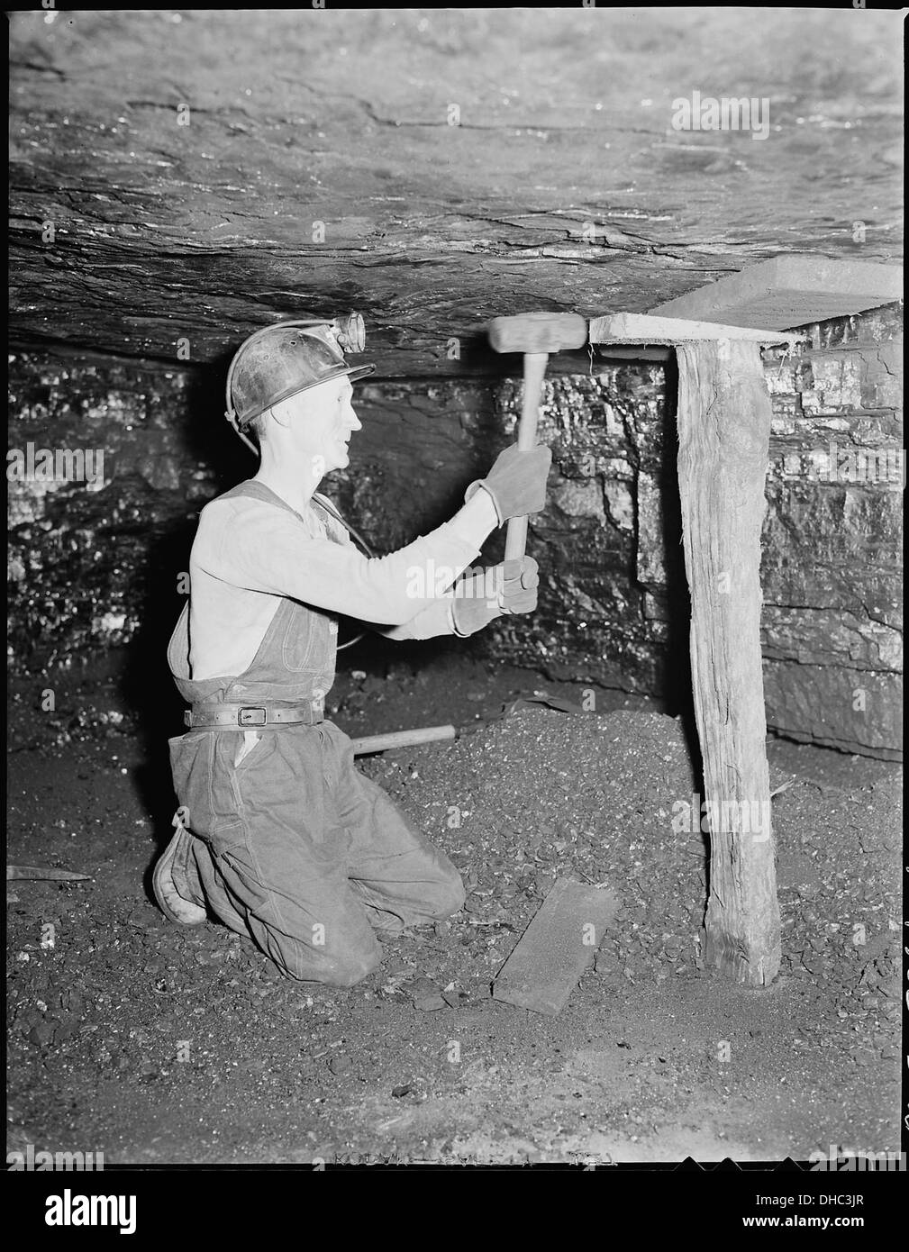 Harry Fain, a coal loader, secures safety timber near his work area in ...