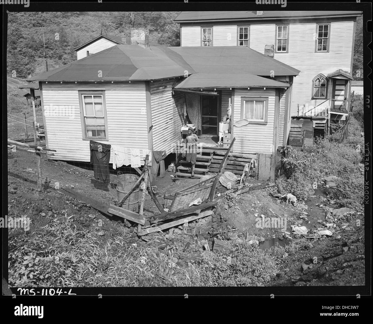 A miner’s home in a company housing project, with a church in the ...