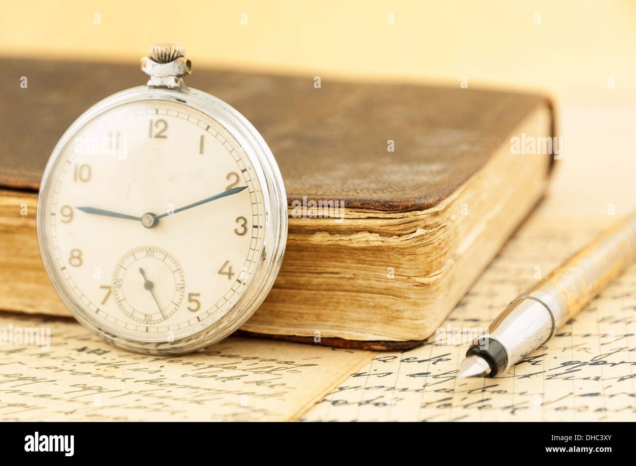 Antique book and pocket watch Stock Photo - Alamy