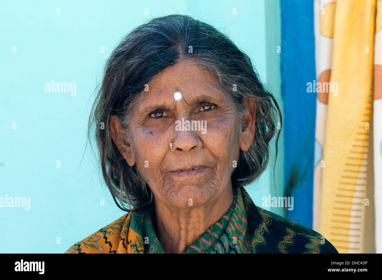 South Indian grandmother stood in from of her family home in ...