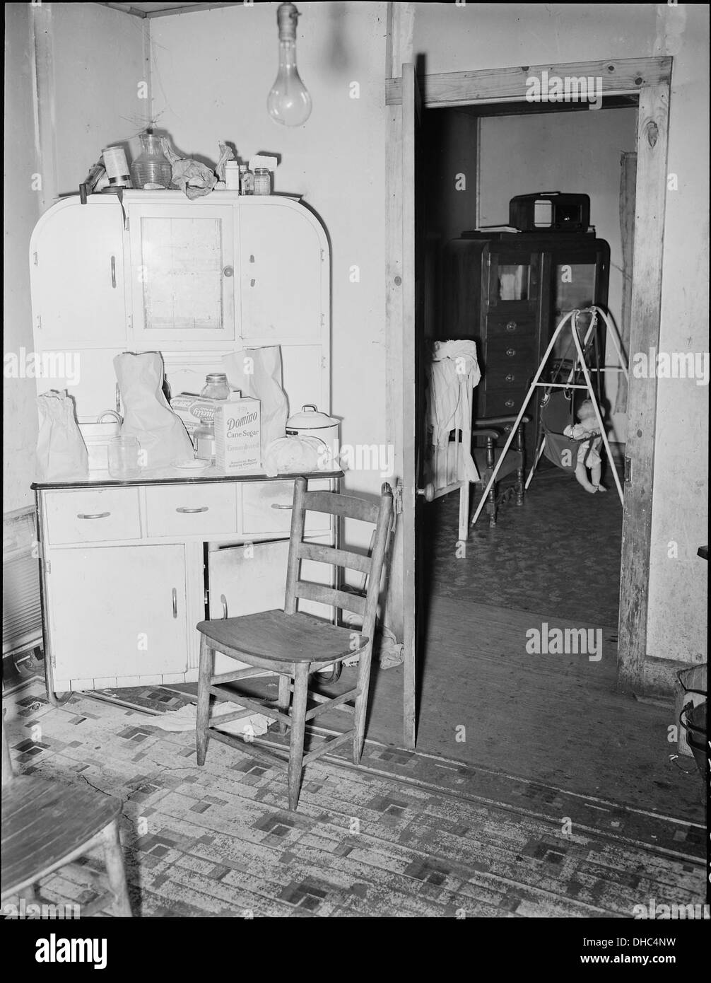 This photograph depicts the kitchen in the four-room house of the ...