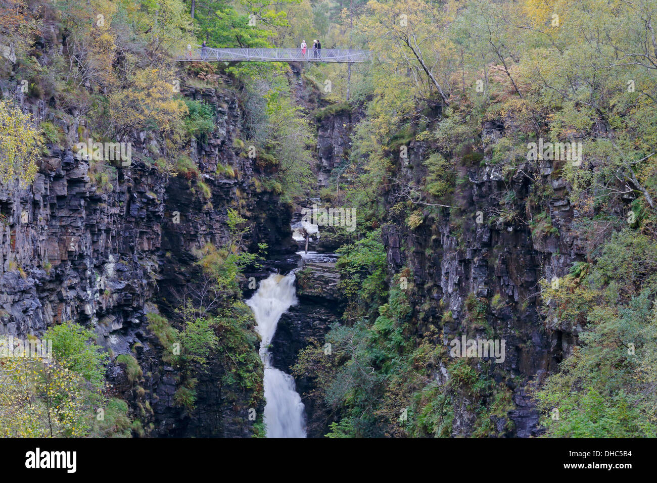 Three people on suspension bridge over Corrieshalloch Gorge Stock Photo ...