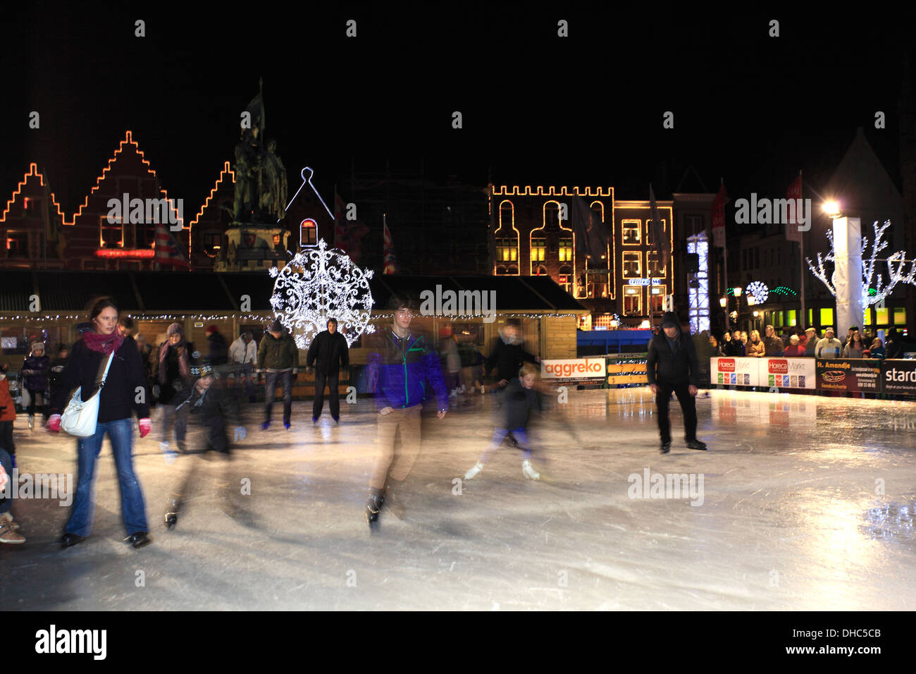 Panned camera effect on People skating on the Christmas Ice rink ...