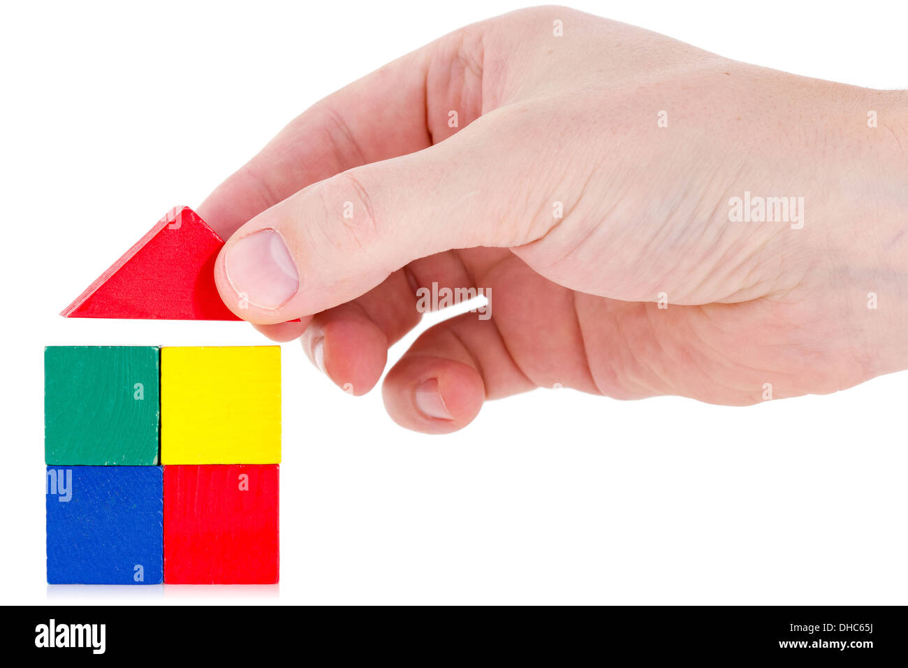 Human hand building a house using wooden blocks. Isolated on white ...