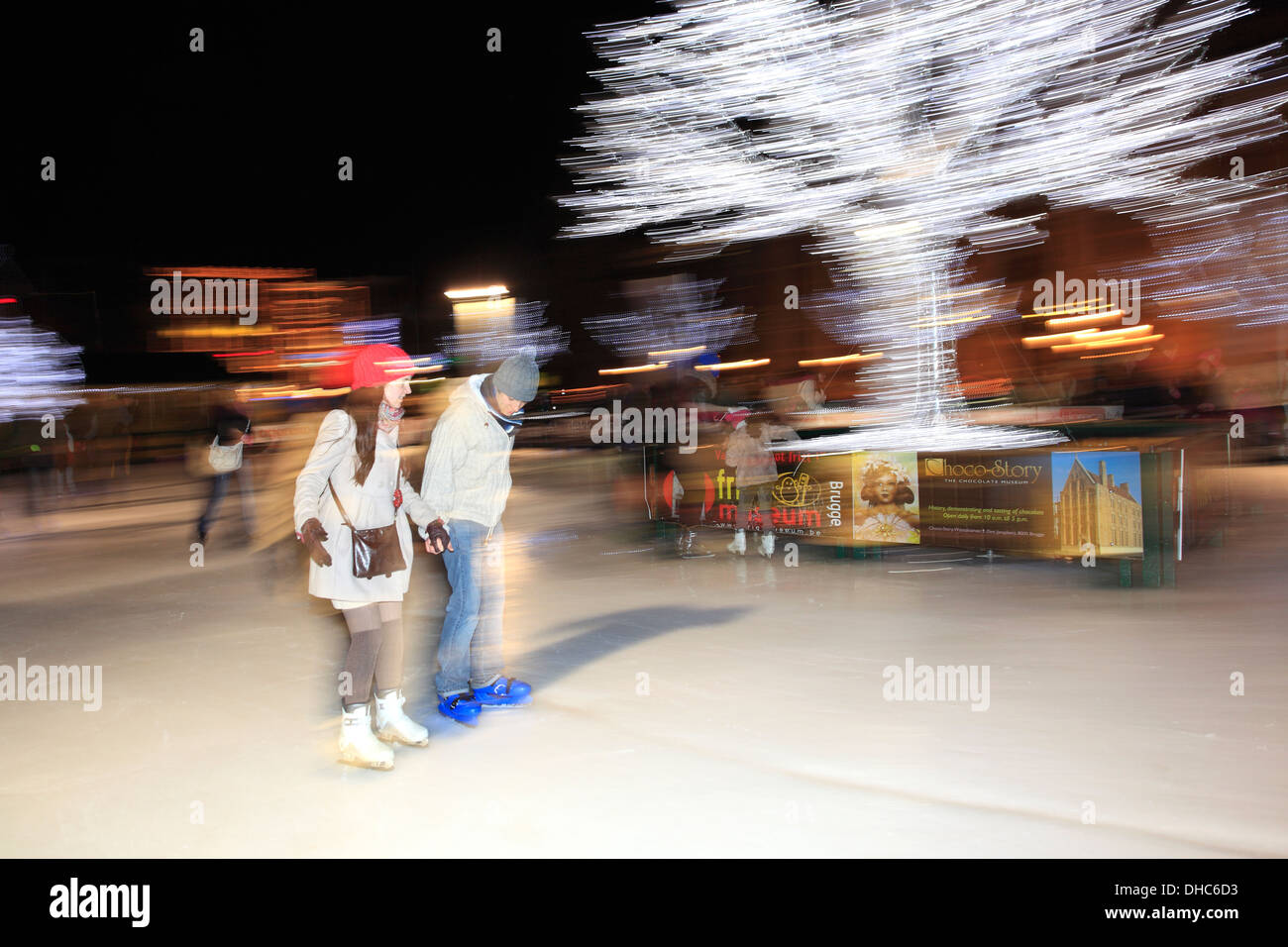 Panned camera effect on People skating on the Christmas Ice rink ...
