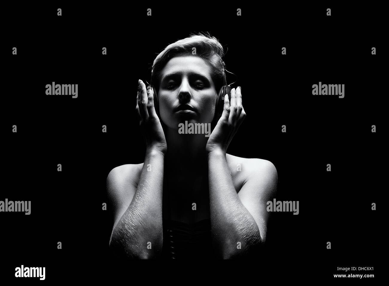 beautiful woman in tense black and white light listening to music Stock ...