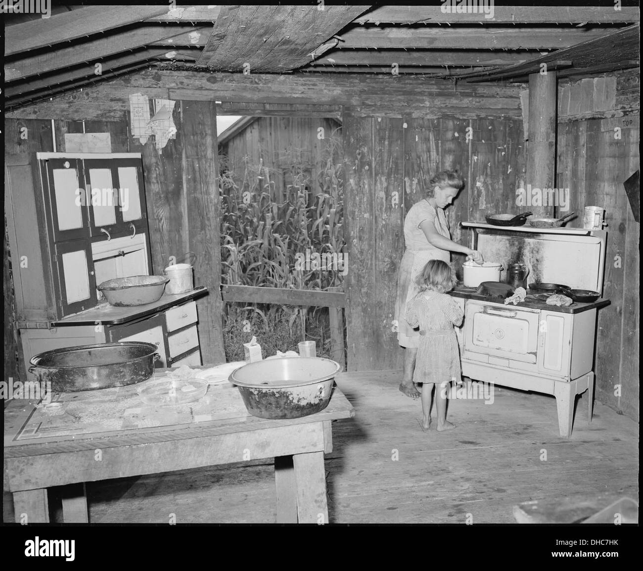 Mrs. Monroe Jones in the kitchen of the four room house which serves as ...