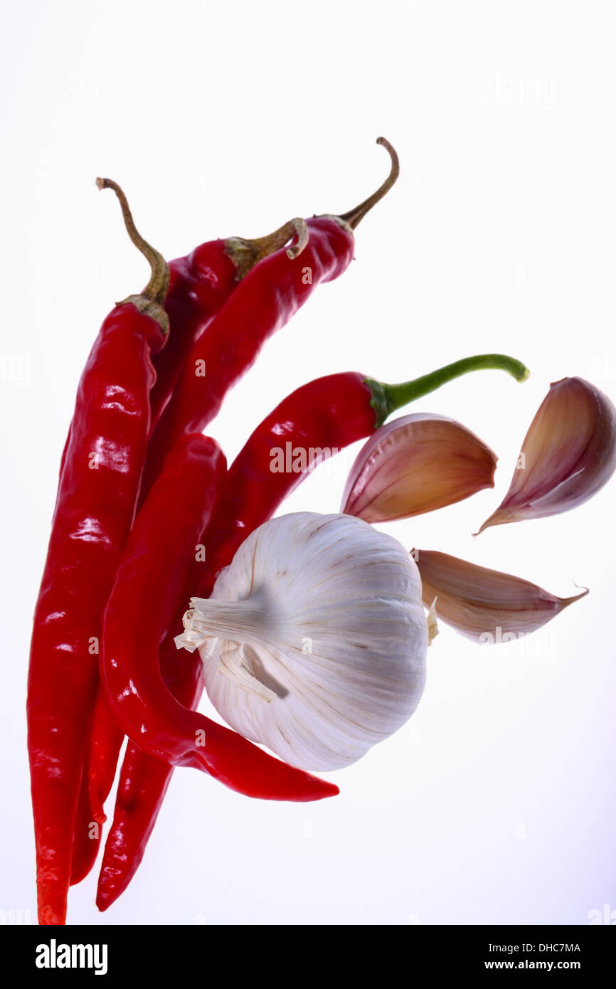 Collection of garlic and chillies on a white background Stock Photo - Alamy
