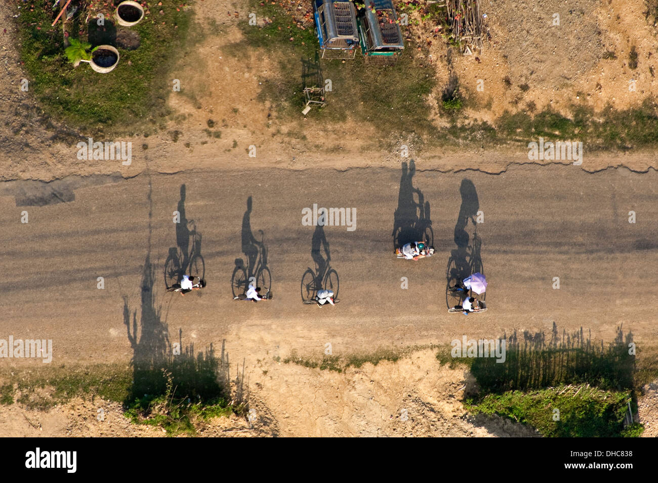 Horizontal overhead view of people riding along the road on bikes in ...
