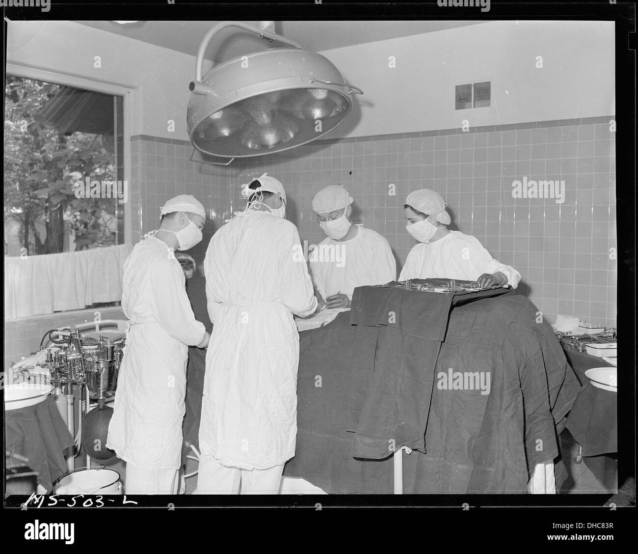 Doctors perform a medical operation at the company-owned hospital of ...