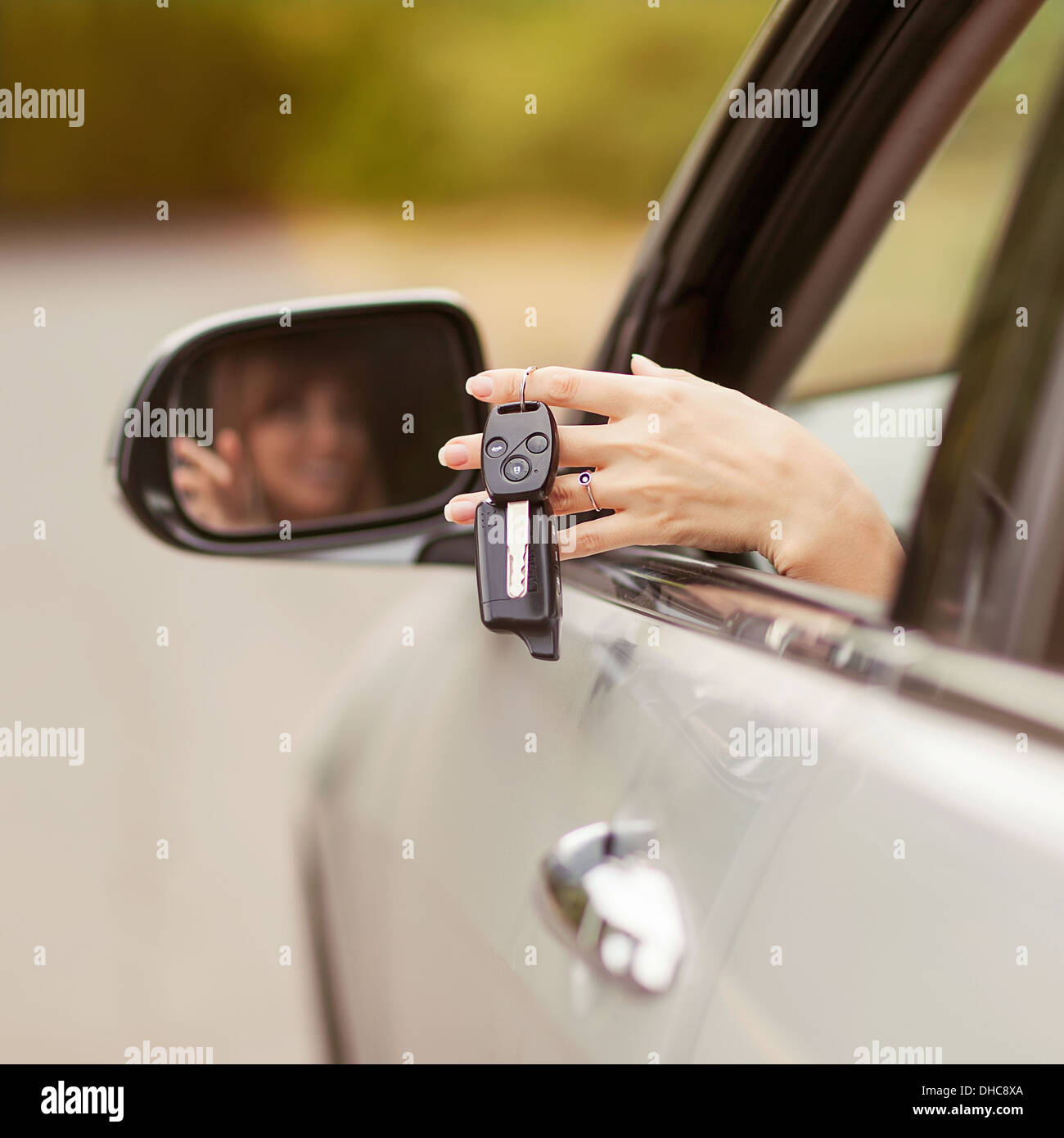 Cheerful girl holding car keys from window Stock Photo - Alamy