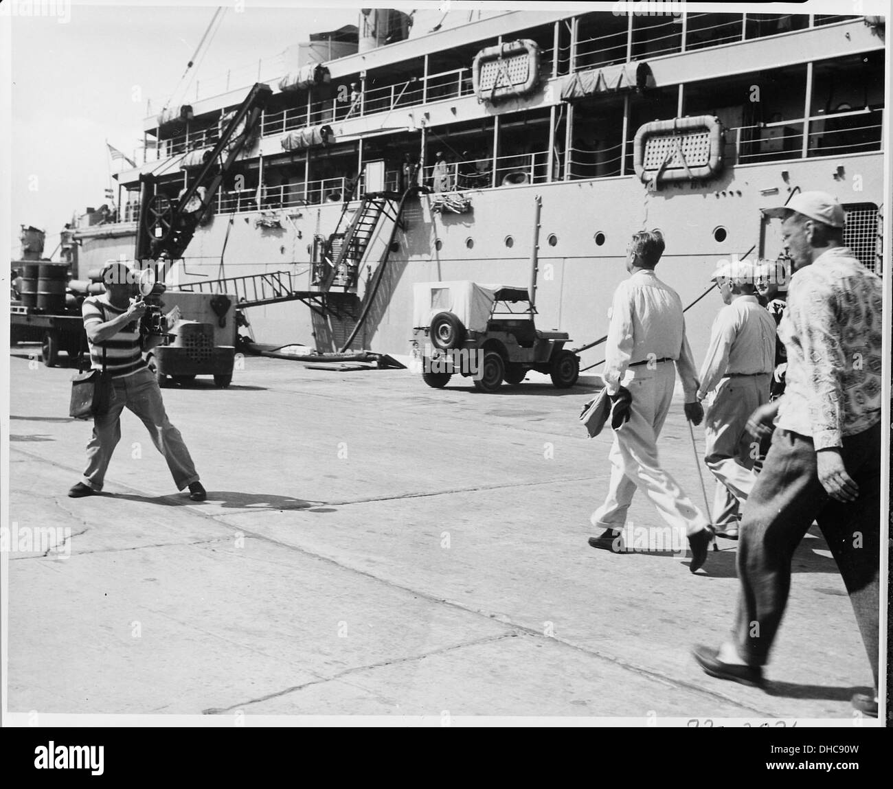 This photograph shows President Harry S. Truman walking to the beach in ...