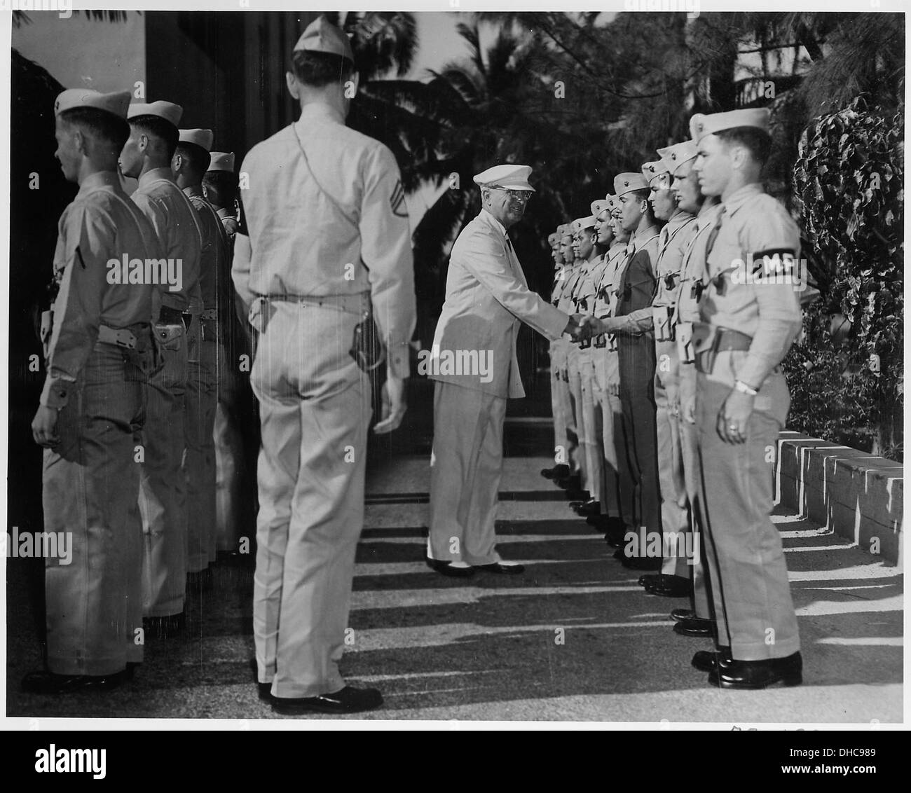 President Truman is seen shaking hands with members of the Marine ...