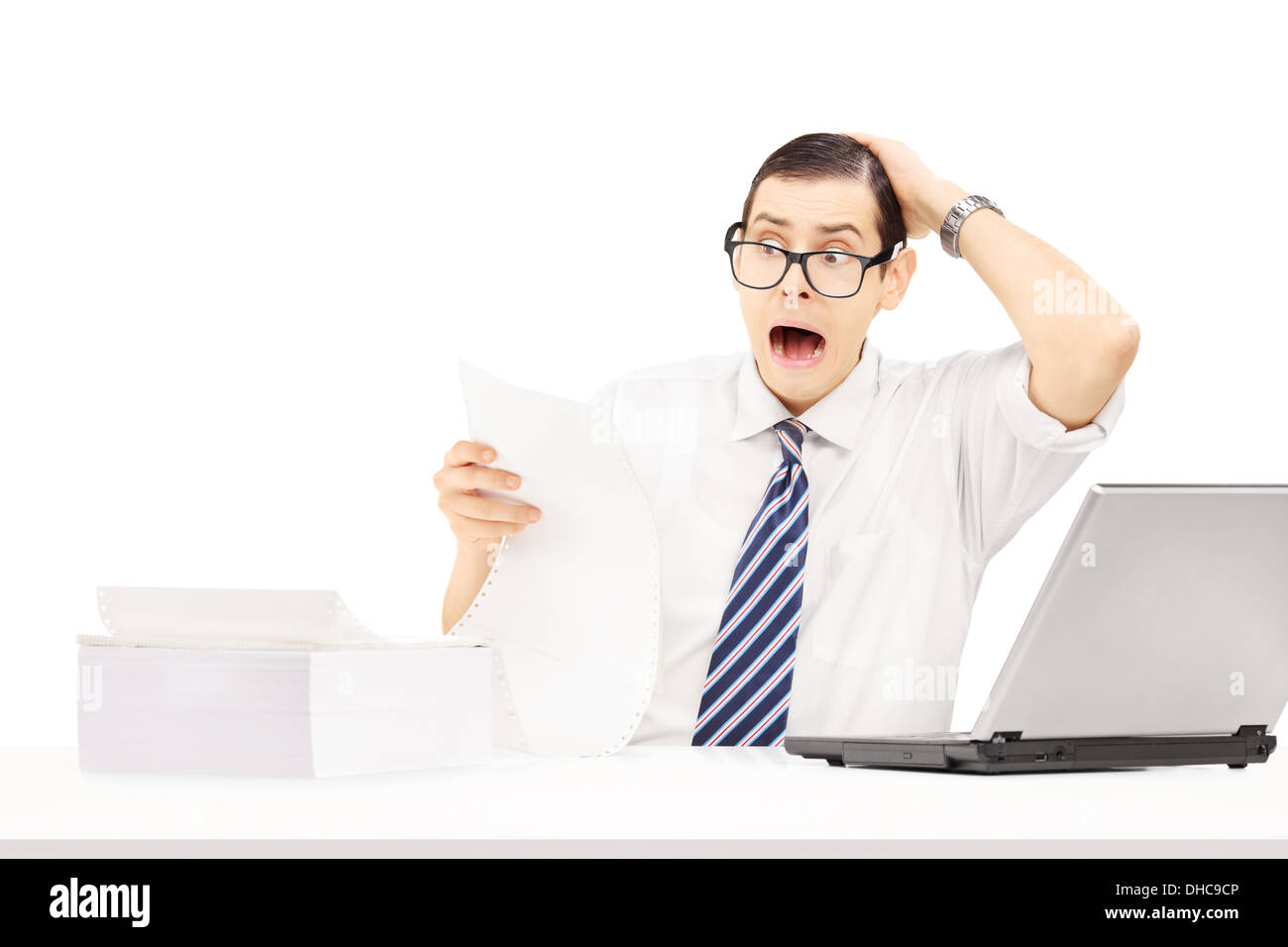Shocked businessman at his workplace looking at very expensive bill ...