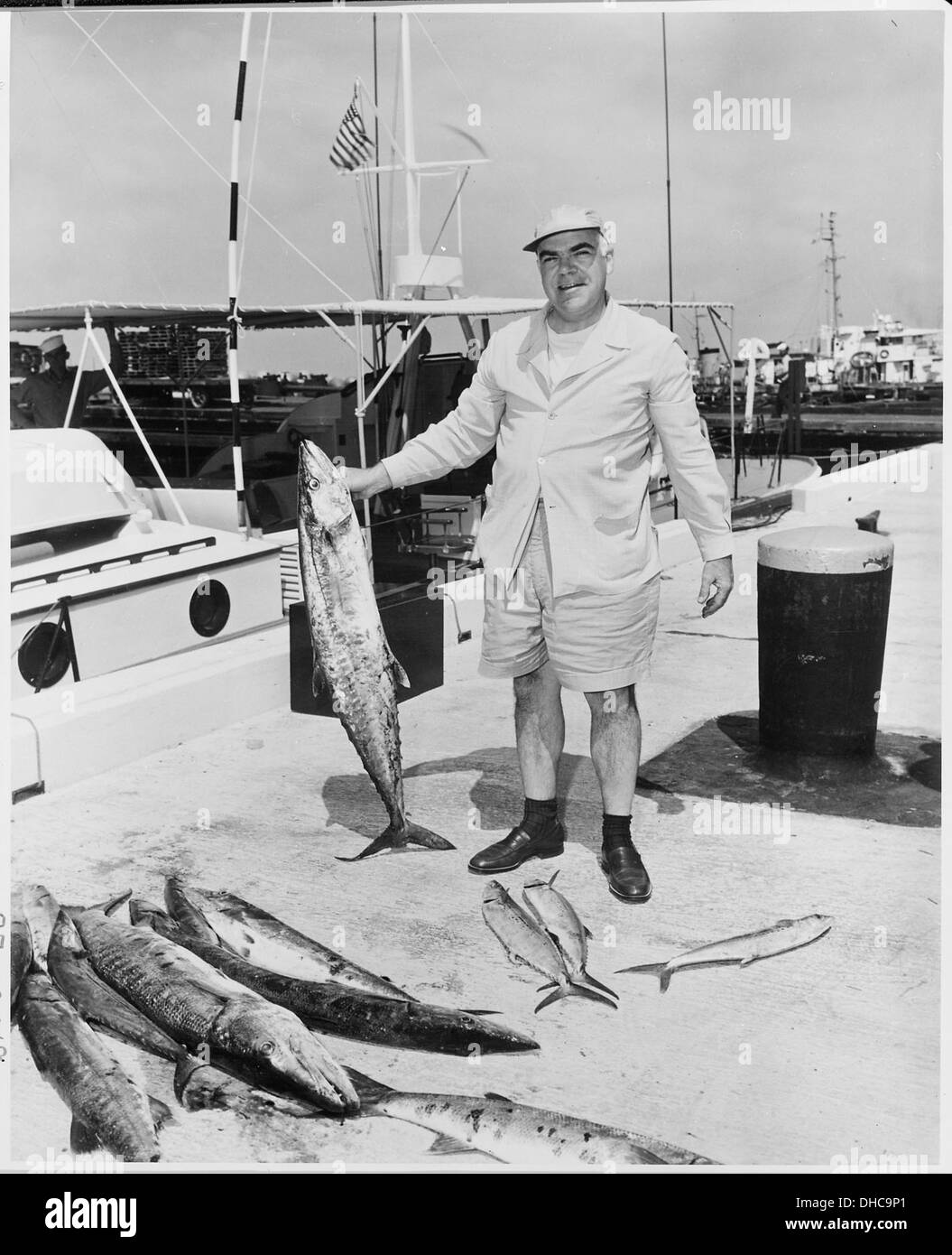 White House aide Philleo Nash holds a fish he caught during President ...