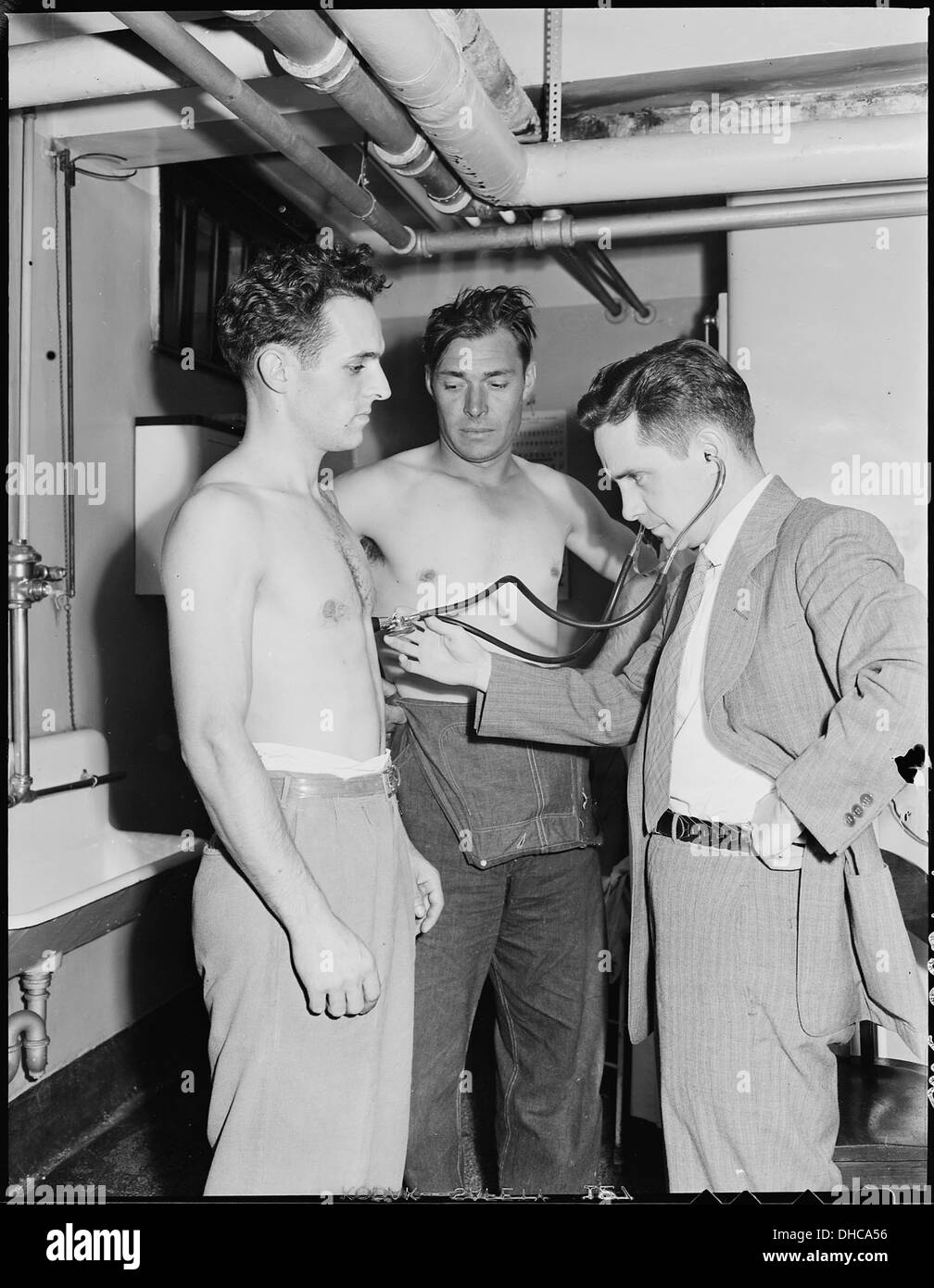 A doctor conducts a pre-employment medical examination of miners at a ...