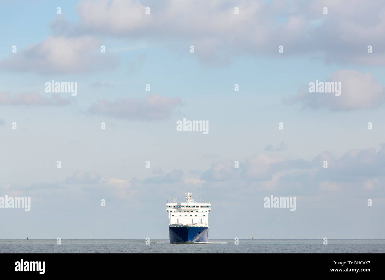 Cargo ship sails into the Thames Estuary, River Thames, Essex, England ...