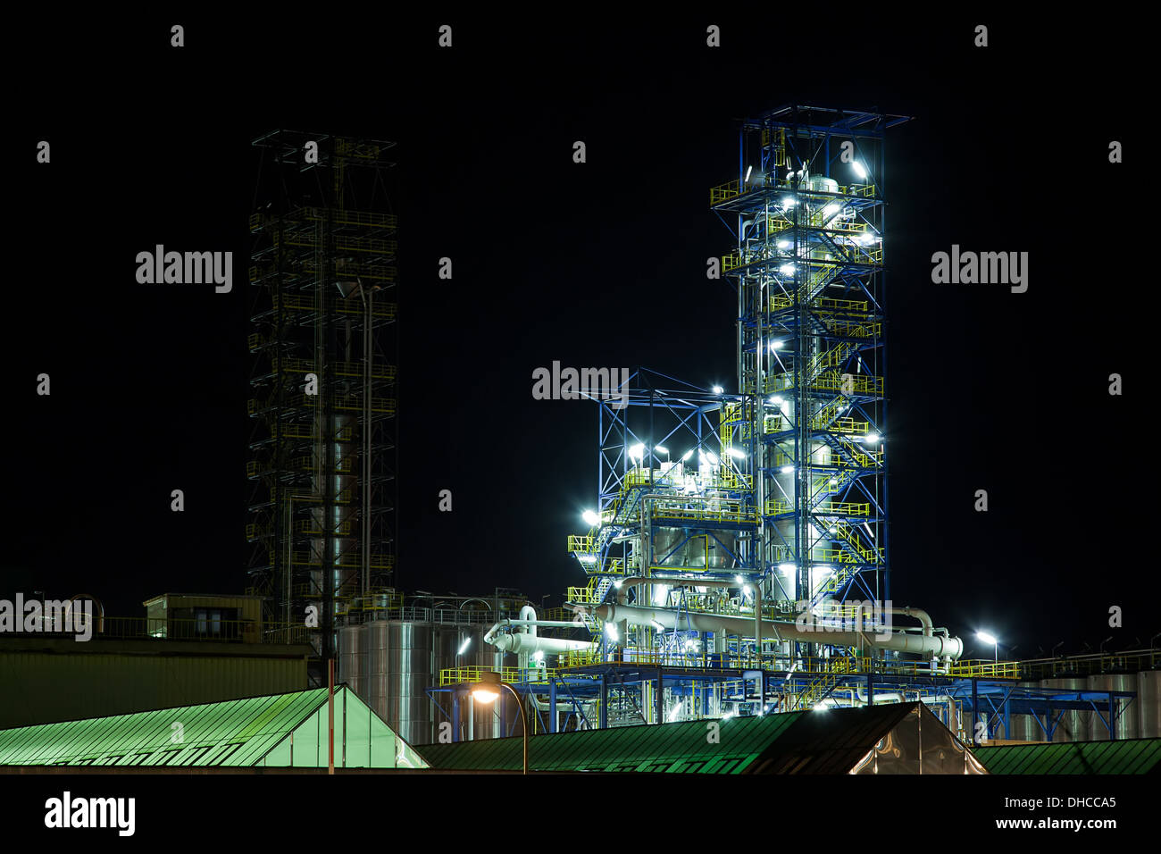 Refinery distillation tower at night Stock Photo - Alamy