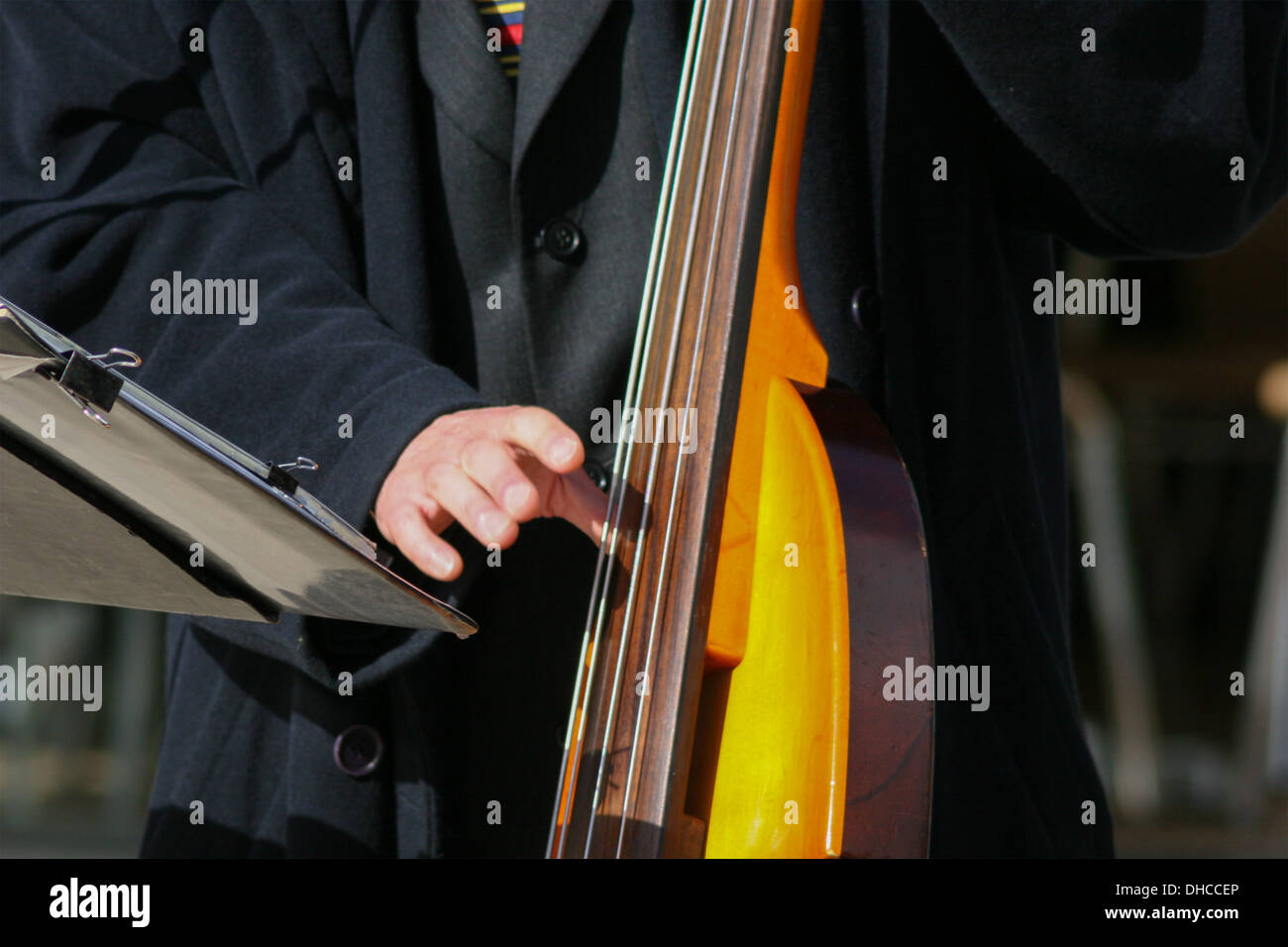 Busker playing double bass and singing in Bournemouth town center ...