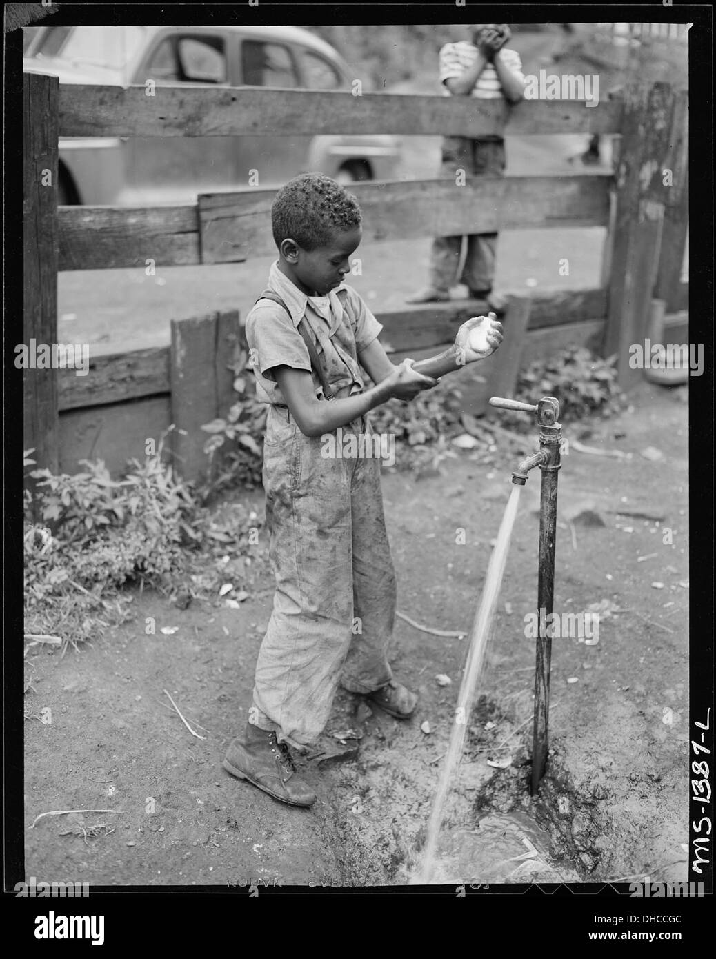 The photograph shows the son of James Robert Howard washing his hands ...