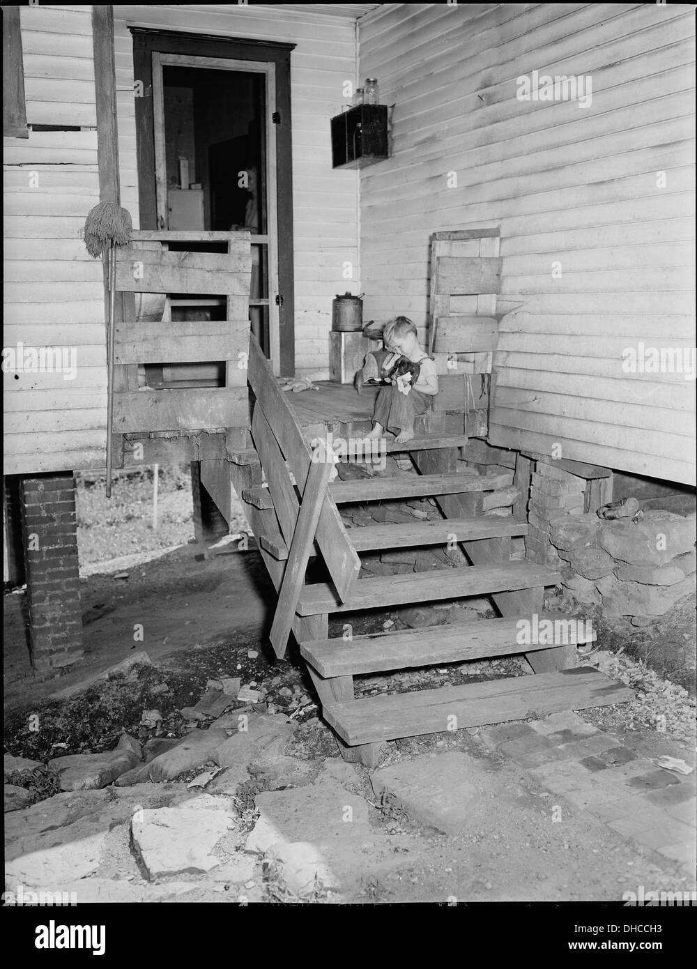 The son of Milong Bond, a tipple worker, stands on the back porch of ...