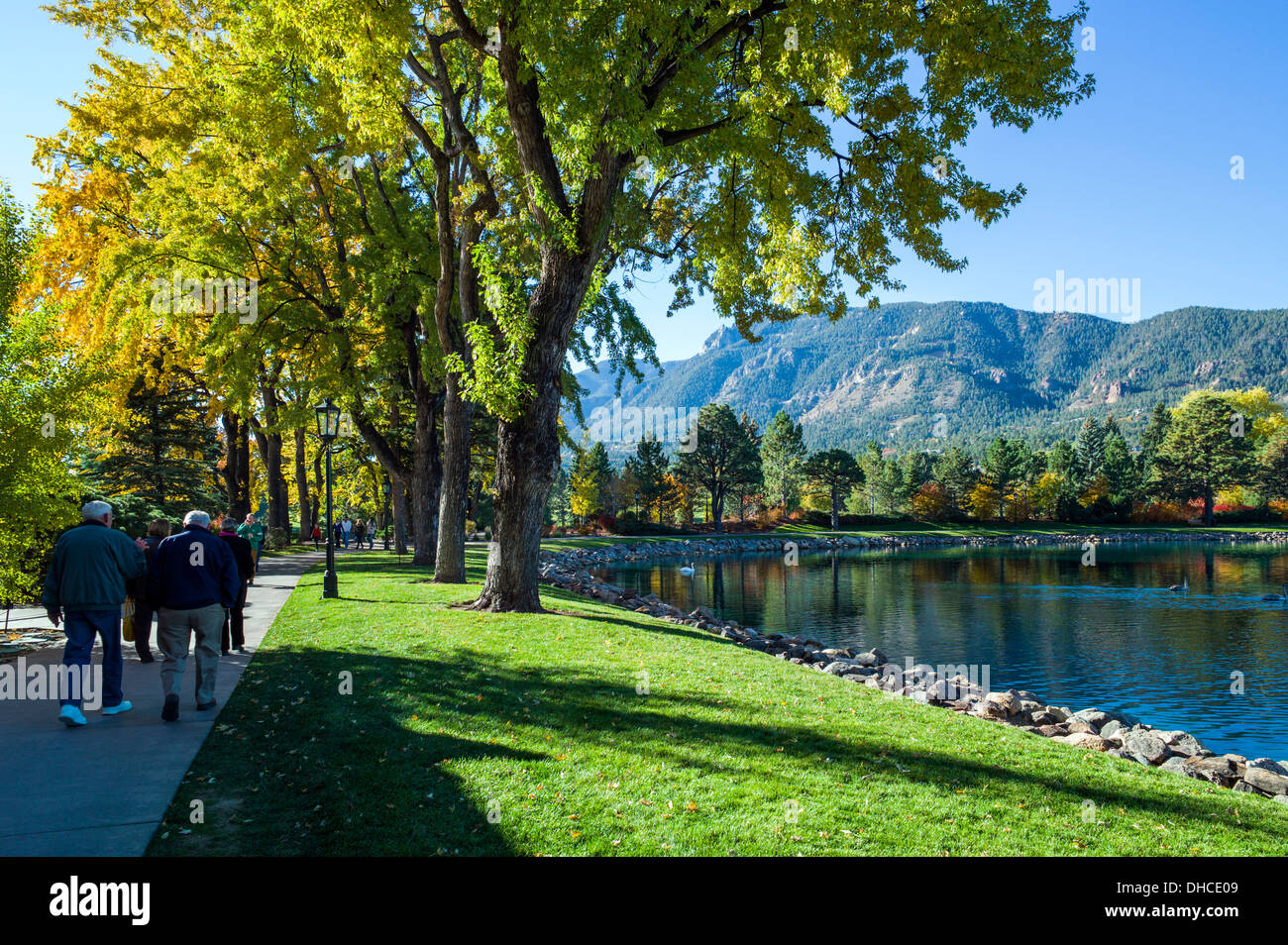Tourists stroll the path along Cheyenne Lake, The Broadmoor, historic ...