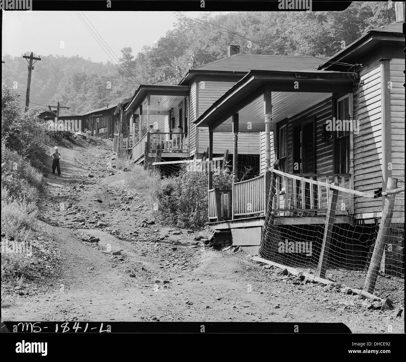 The image depicts typical houses and a street in a mining community ...