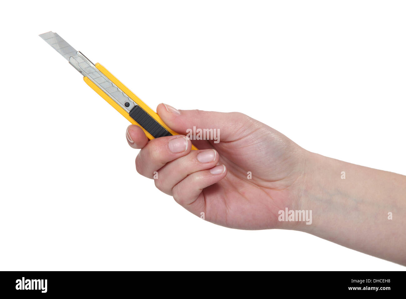 Hand holding a utility blade Stock Photo - Alamy