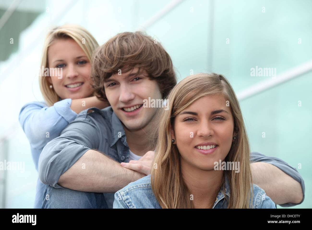 three students sitting on stairs Stock Photo - Alamy