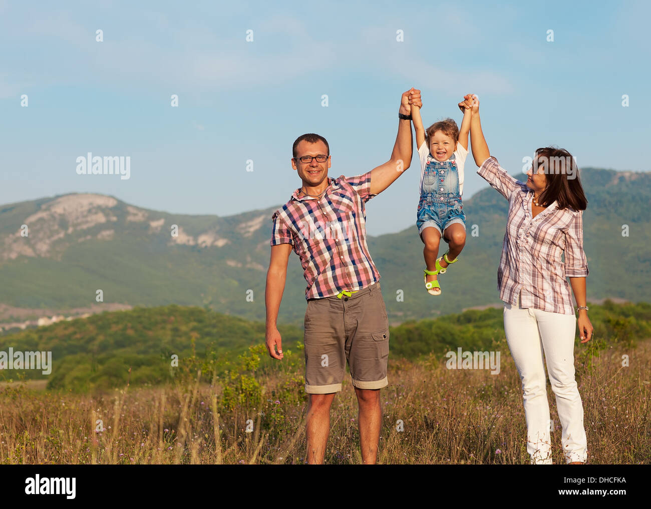 Happy family having fun outdoors and smiling Stock Photo - Alamy
