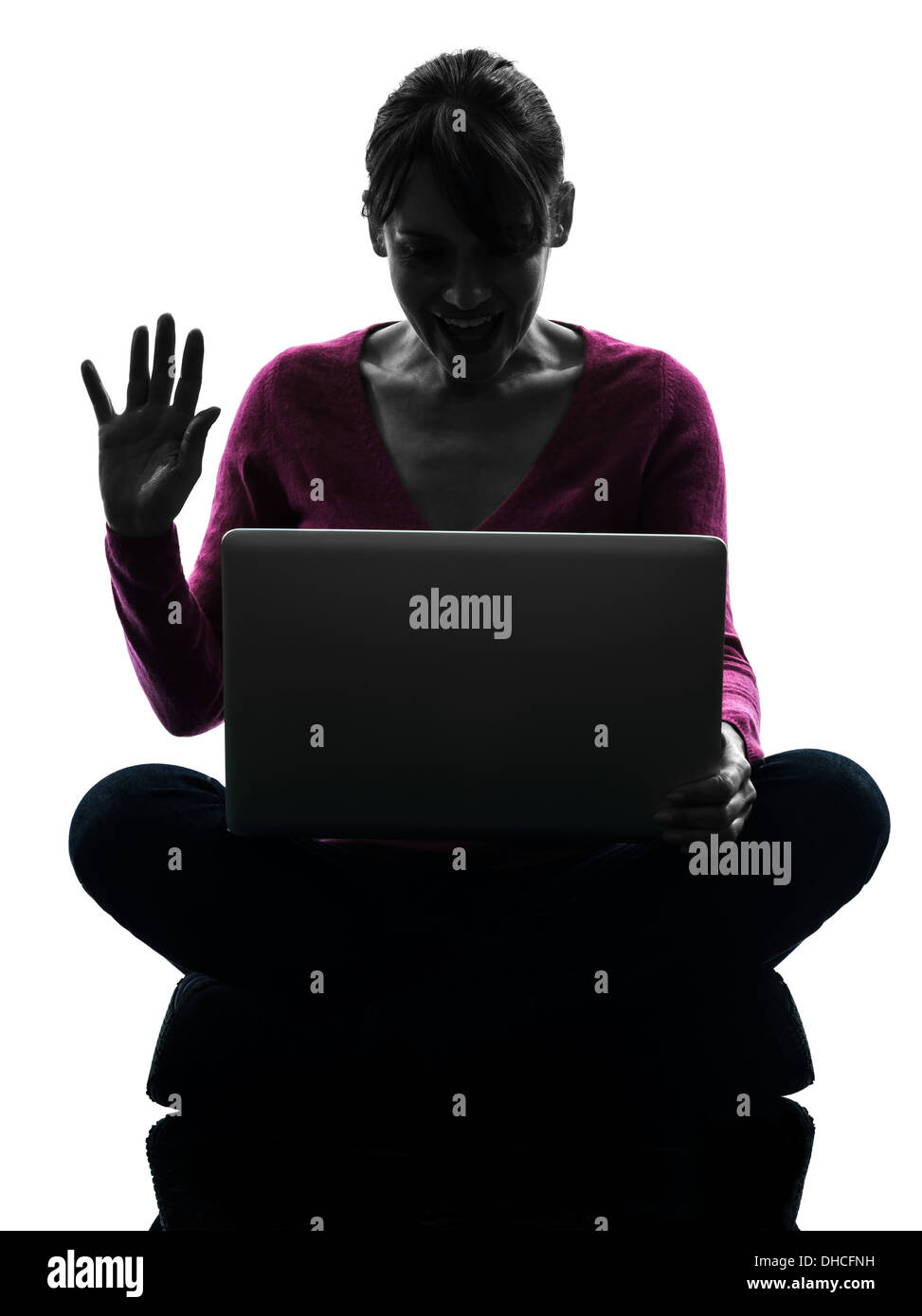 one woman saluting computing laptop computer in silhouette studio ...
