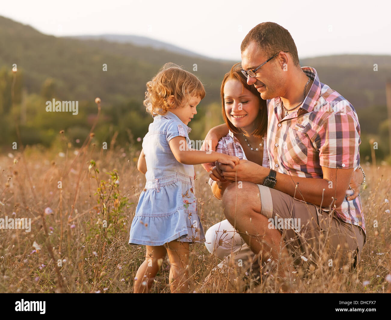 Happy family having fun outdoors and smiling Stock Photo - Alamy