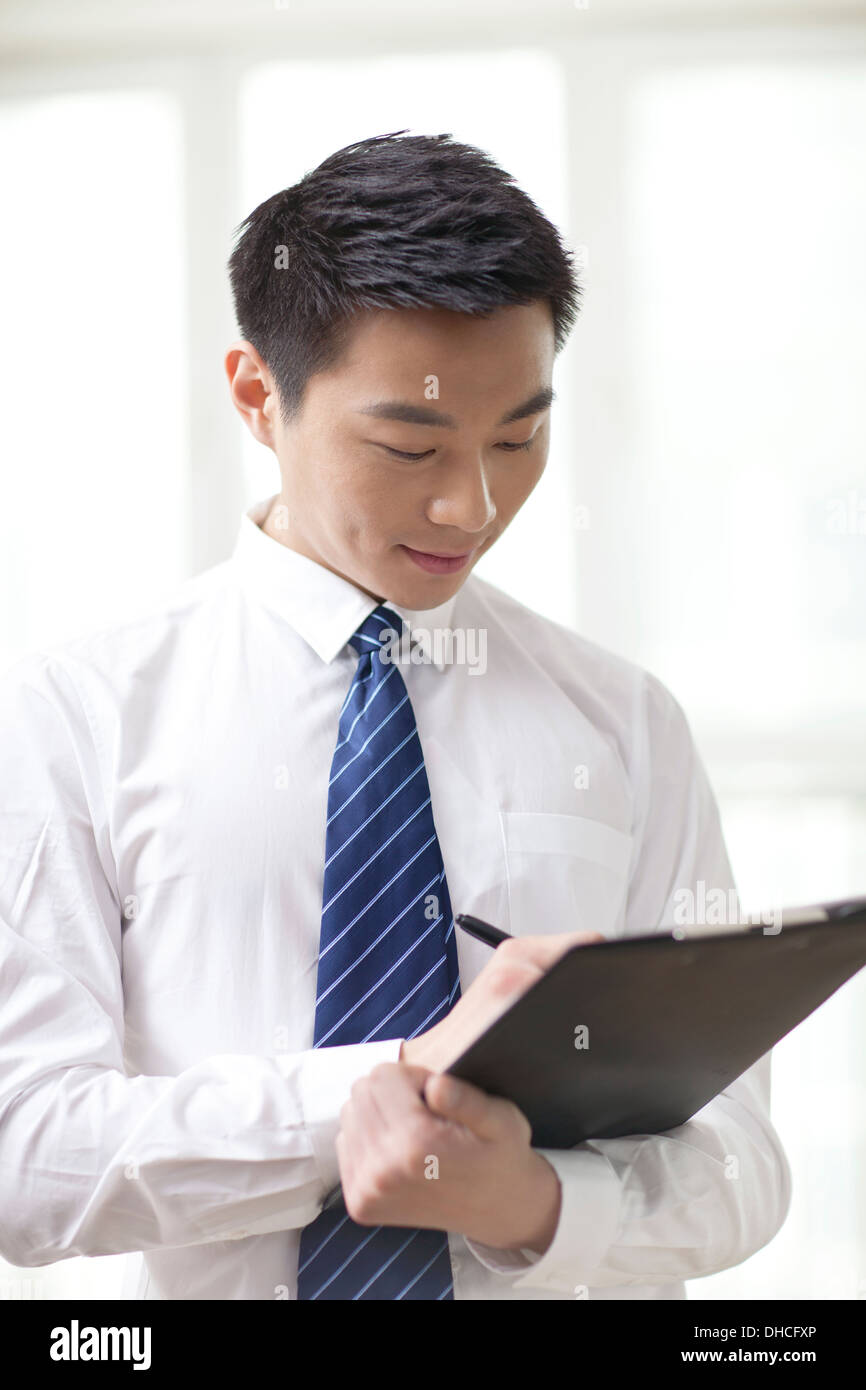 Young businessman looking documents hi-res stock photography and images ...